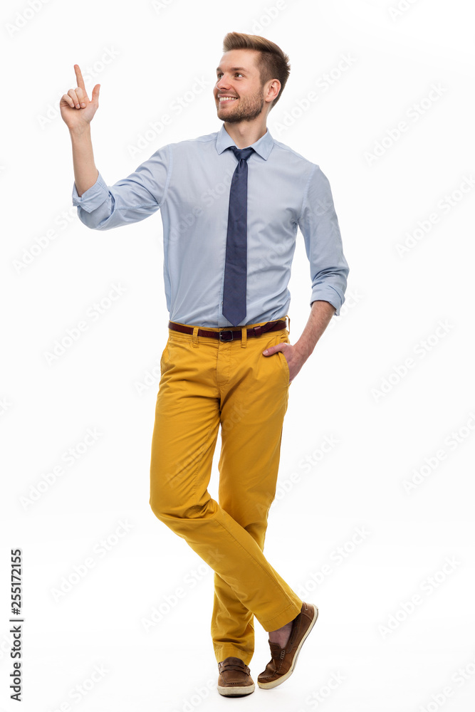 Full length portrait of young man pointing Stock Photo | Adobe Stock
