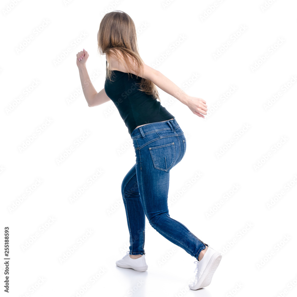 Woman in jeans walking goes running on white background isolation, back ...