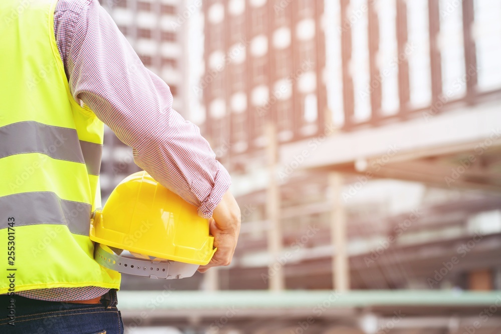 Close up backside view of engineering male construction worker stand ...