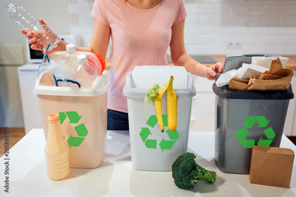 Waste sorting at home. Recycling. Woman putting plastic bottle in the ...