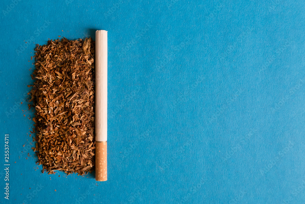 A cigarette separates tobacco from a clean place for writing text on a ...