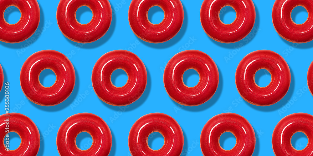 Creative pattern red donuts flat lay on pastel blue background. Minimal ...