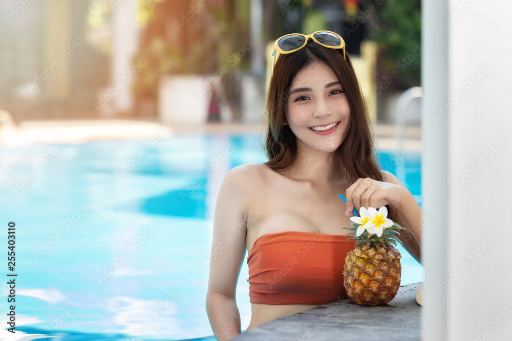 Foto de Sexy young asian woman in swimsuits in summer. beautiful woman in orange bikini with ...