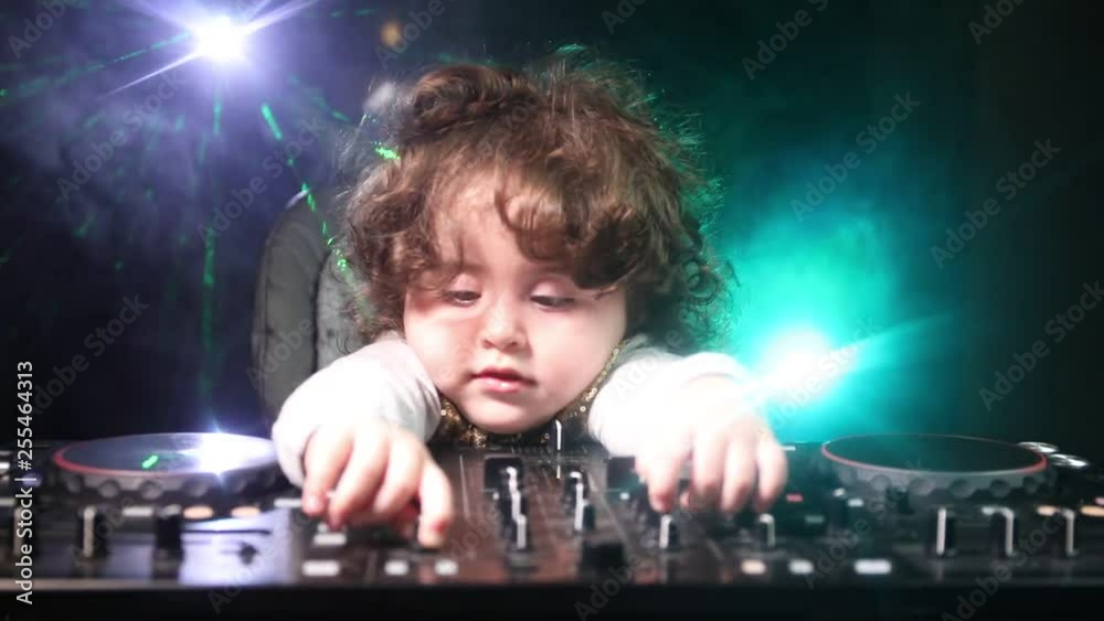 Funny Dj club concept. Cute baby girl mixing on dj`s deck at night club ...