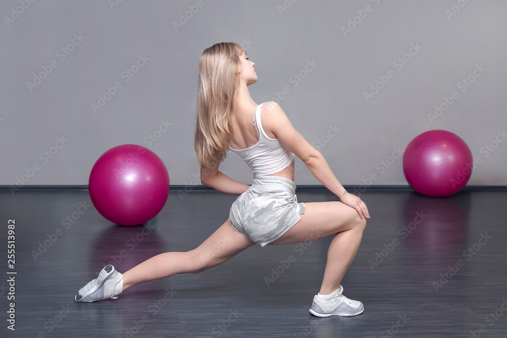 Blond Sporty Caucasian Lady is in the Gym during Training, Exercises to ...