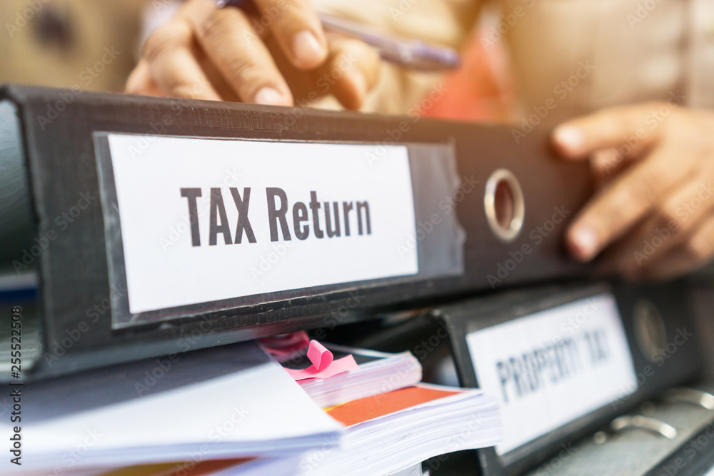 Tax return and property tax folders stack with label black binder on ...