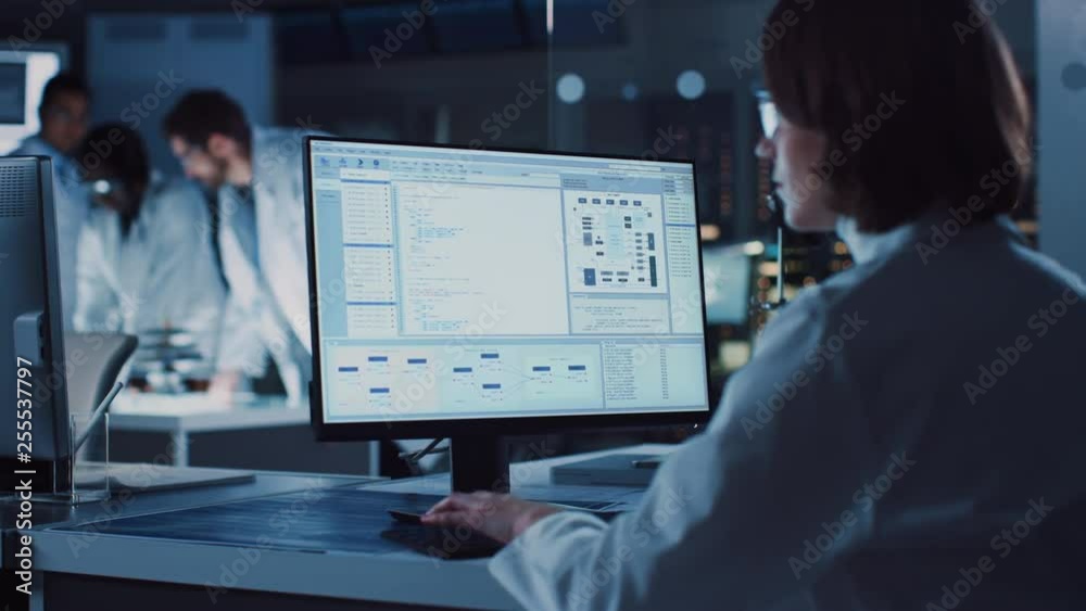 Over the Shoulder Shot: Female IT Scientist Uses Computer Showing ...