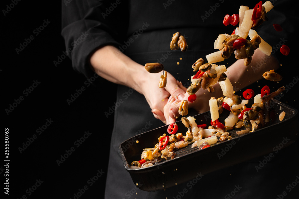 Professional chef prepares seafood with hot chili peppers. octopus ...