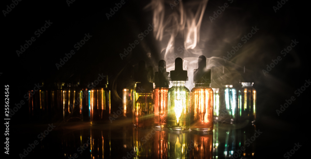 Vape concept. Smoke clouds and vape liquid bottles on dark background ...