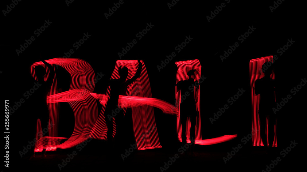 Human silhouette against red backlight title BALI on black background ...