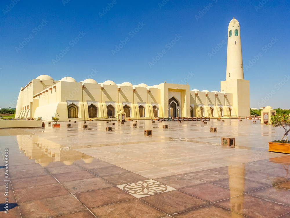 State Grand Mosque with a minaret reflecting on marble pavement ...