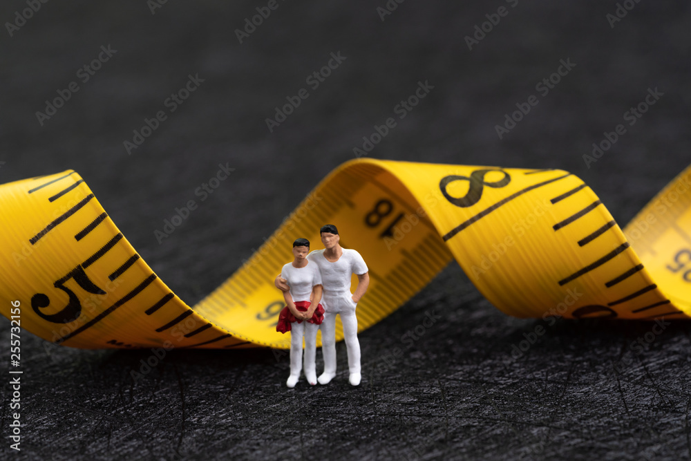 Fitness, exercise or weight control concept, iniature healthy people ...