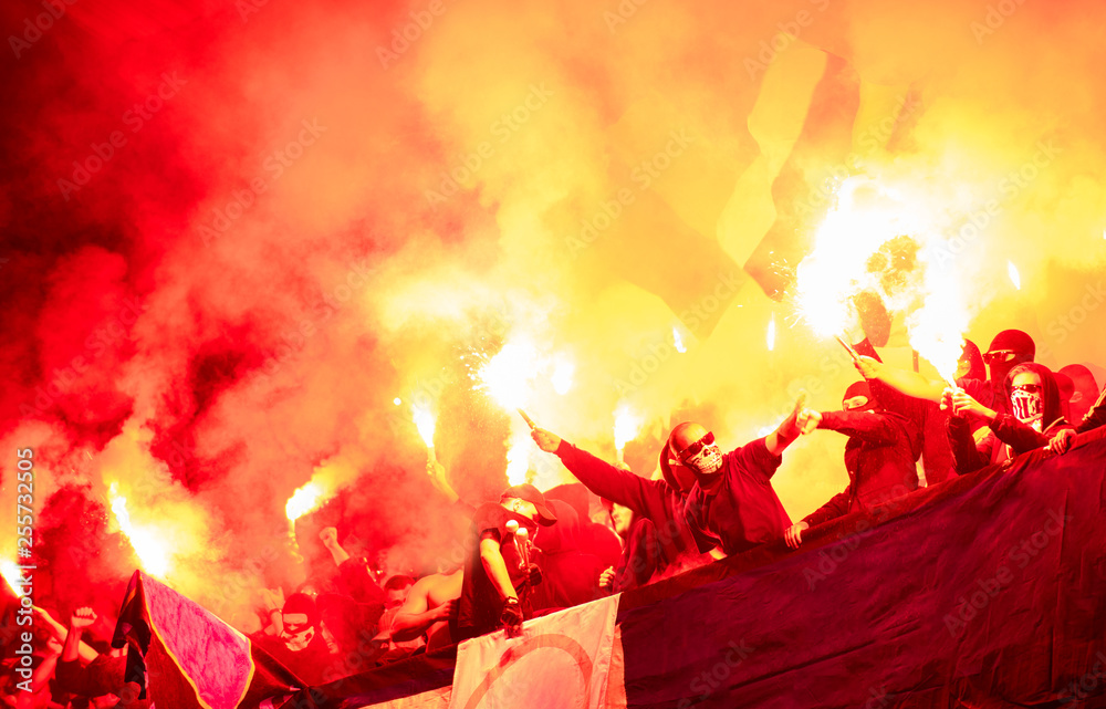 football hooligans with mask holding torches in fire Stock Photo ...