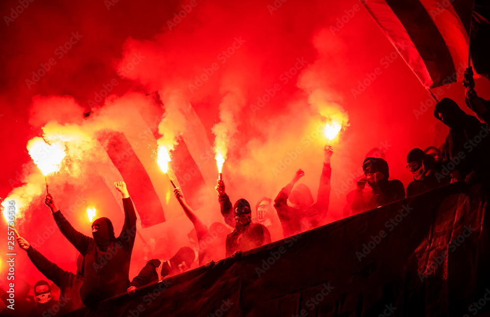 football hooligans with mask holding torches in fire Stock Photo ...