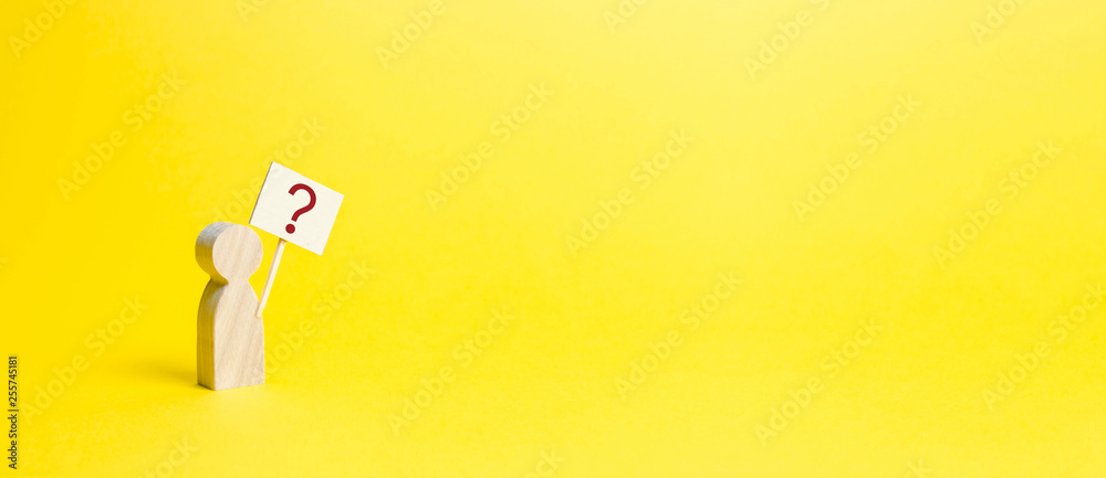 Wooden human figurine with a question mark. Minimalism. Asking a ...