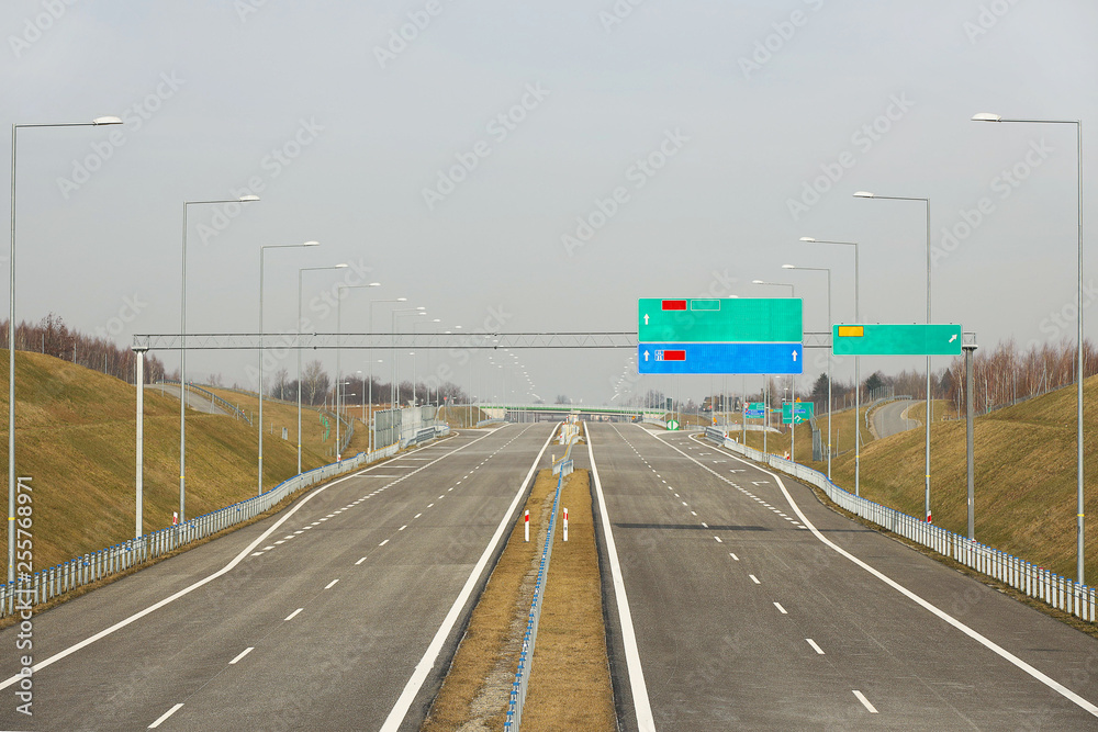 Two-lane motorway with empty road signs. New road without cars. The ...