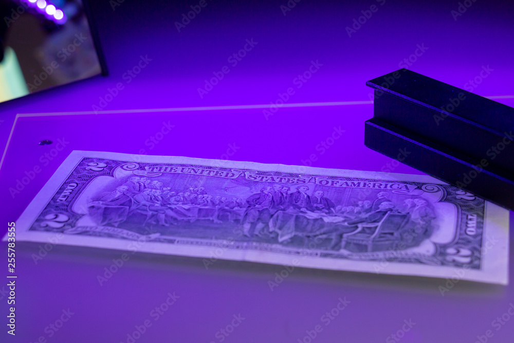 Verifying the authenticity of the two-dollar bill in ultraviolet light ...