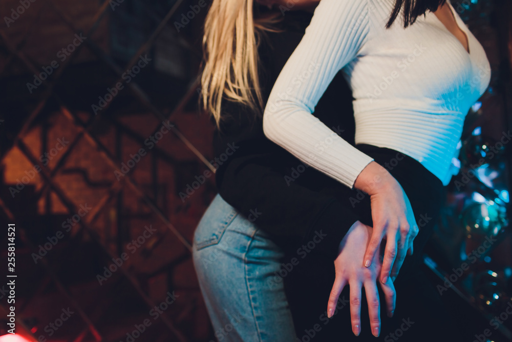 Two girls holding each other hands. Ladies couple the room. Stock Photo ...
