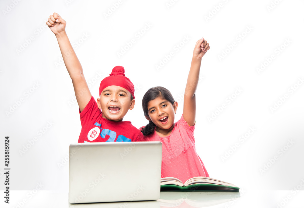 Indian sikh/Punjabi boy and girl studying with books and laptop ...