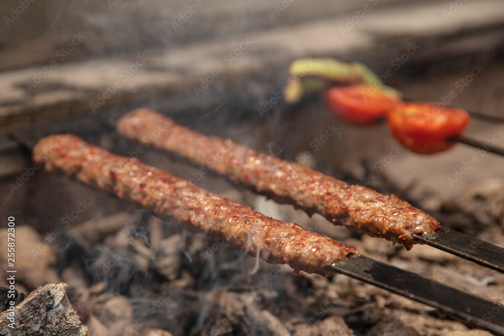 Kebab or kebap on metal skewer barbecue in the kebap restaurant ...