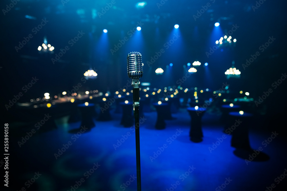 stylish 50s or 60s retro rock microphone on an empty venue stage ...