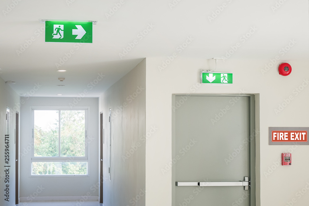 Fire exit sign with light on the path way in the hotel or office Stock ...