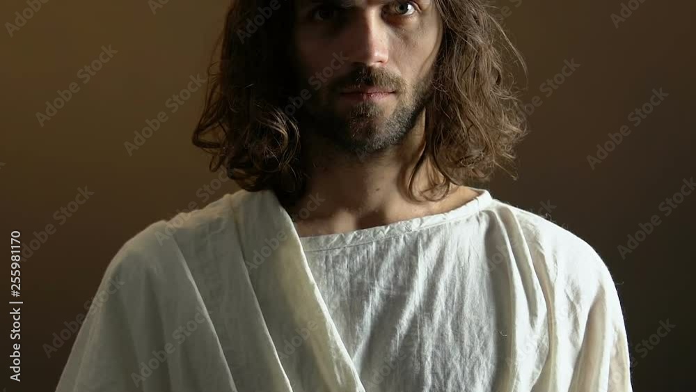 Jesus Christ personification in crown of thorns against dark background ...