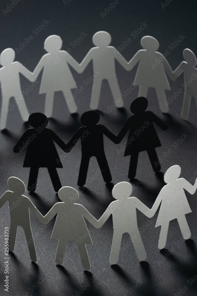 Three human paper figures surrounded by circle of paper people holding ...