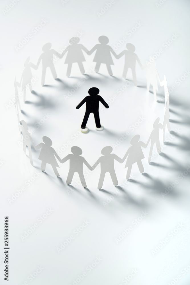 Paper human figure surrounded by circle of paper people holding hands ...