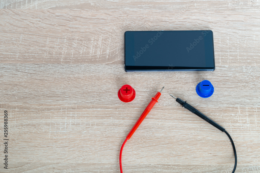 the red and black probes of the multimeter and the signs of polarity of ...
