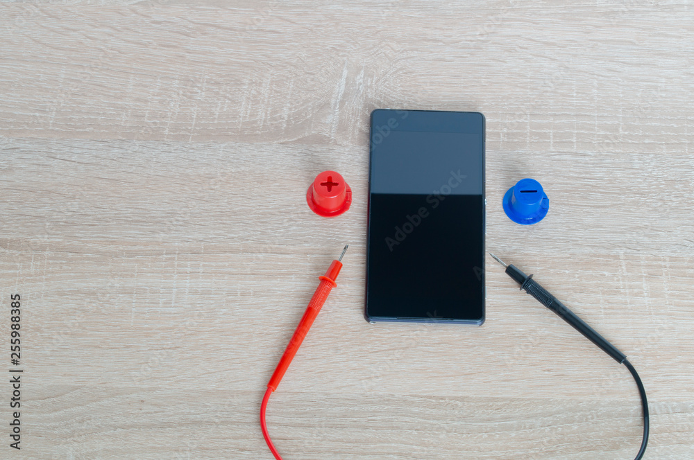 the red and black probes of the multimeter and the signs of polarity of ...