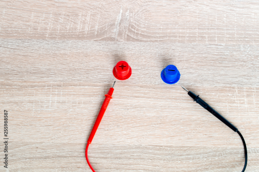the red and black probes of the multimeter and the signs of polarity of ...
