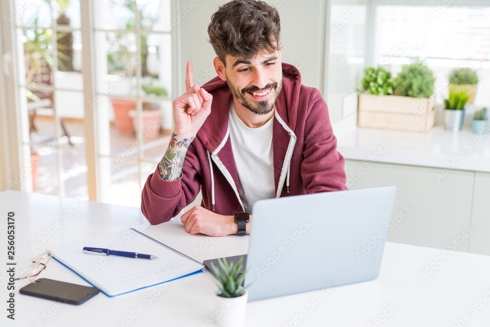 Young student man using computer laptop and notebook surprised with an ...