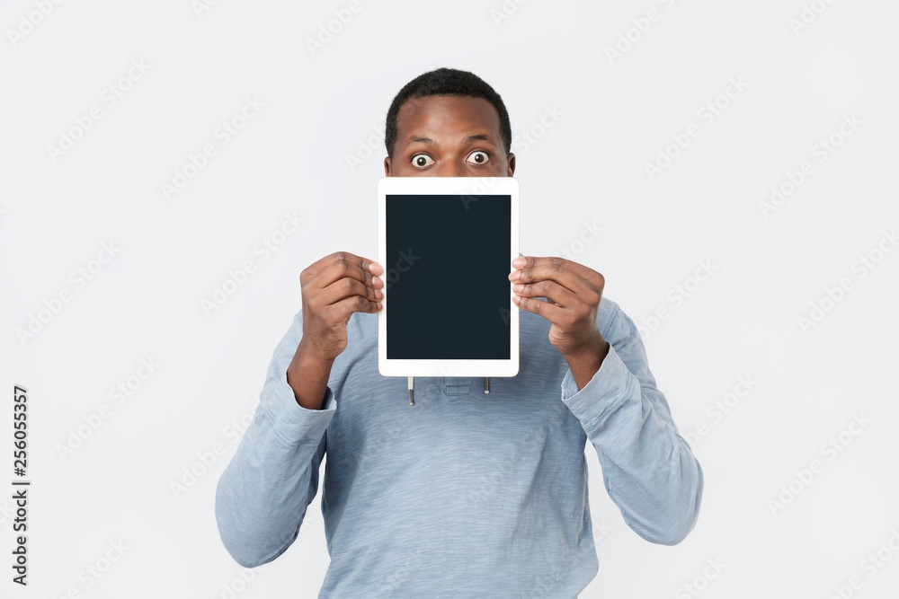 Young African man with tablet showing screen of modern tablet. Stock ...
