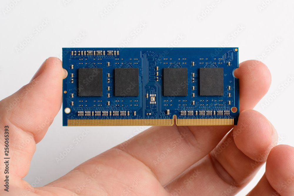 DDR memory card in man`s hand against white background. Upgrading ...