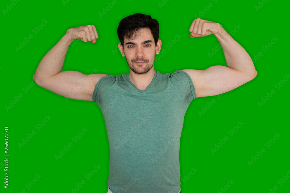 An attractive muscular man showing his biceps on a green screen ...
