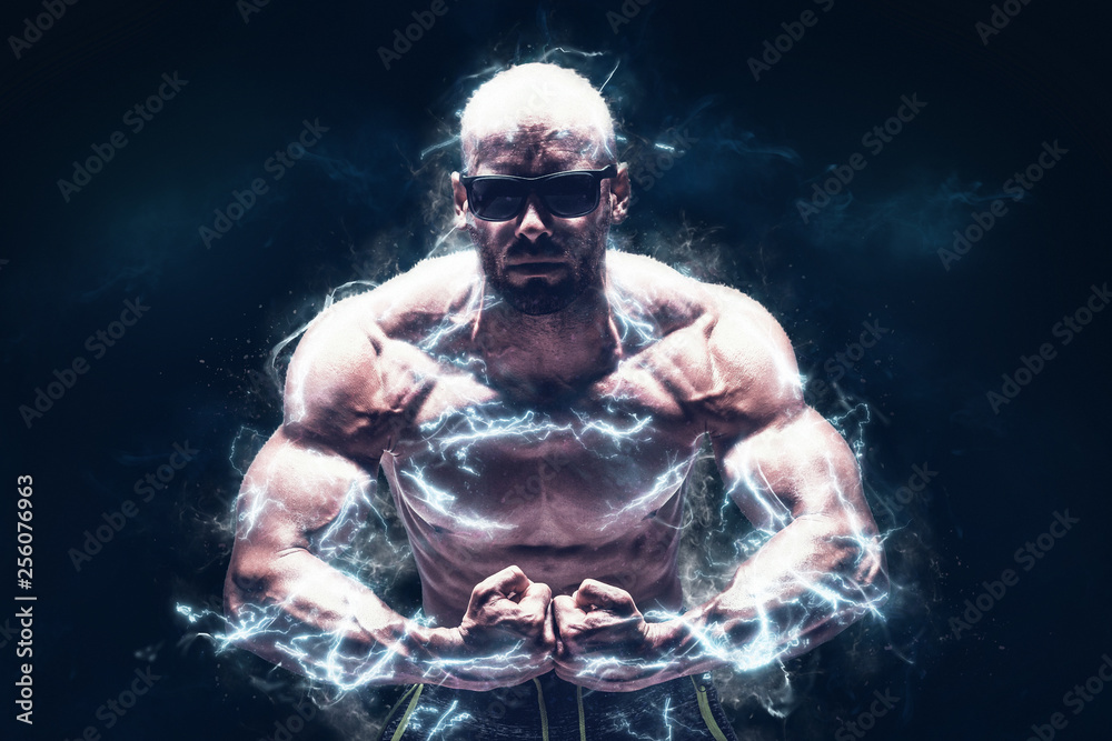 Brutal strong athletic bodybuilder posing. Electric power explosion ...