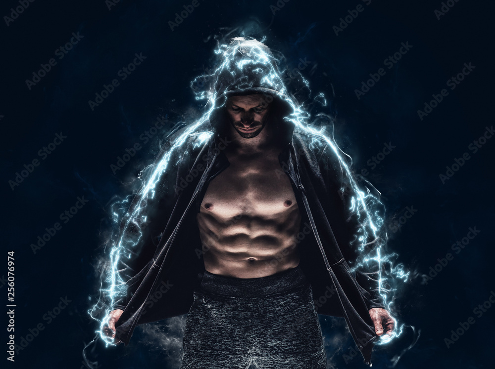 Brutal strong athletic bodybuilder posing. Electric power explosion ...