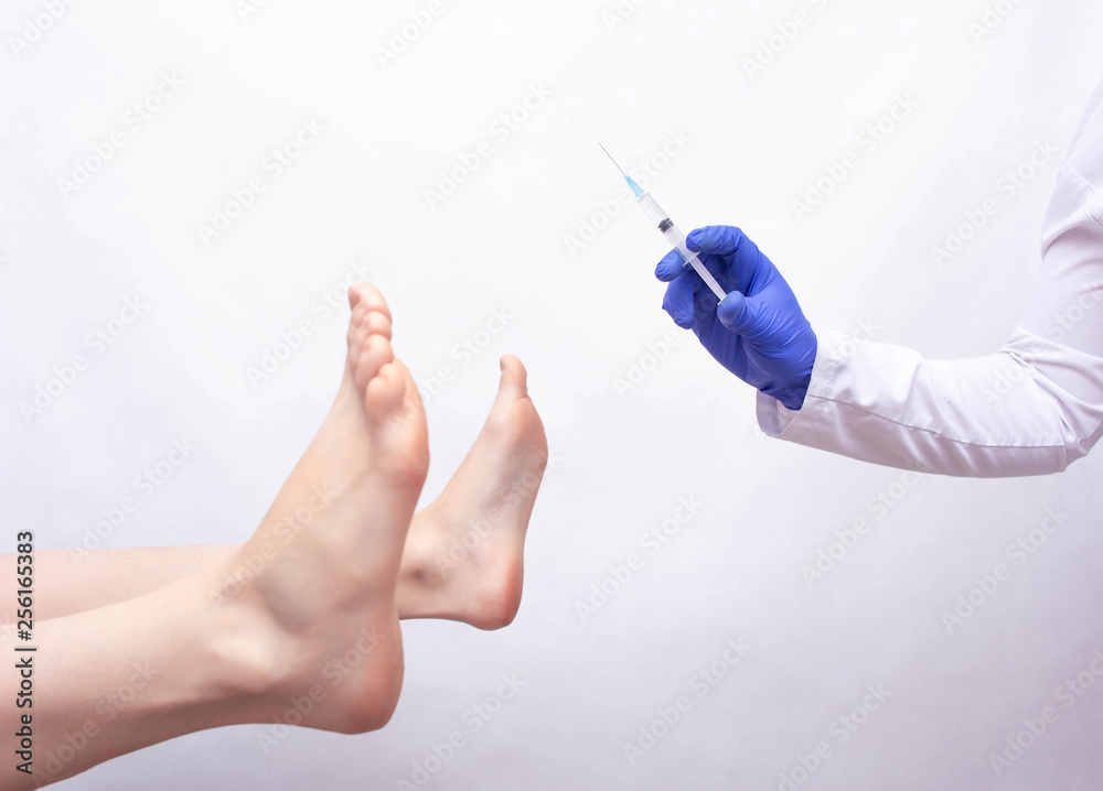 Plastic surgeon doctor holding a syringe on a white background near the ...