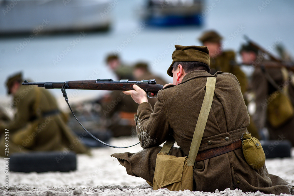 Soldiers fighting on the beach during the reconstruction of the ...