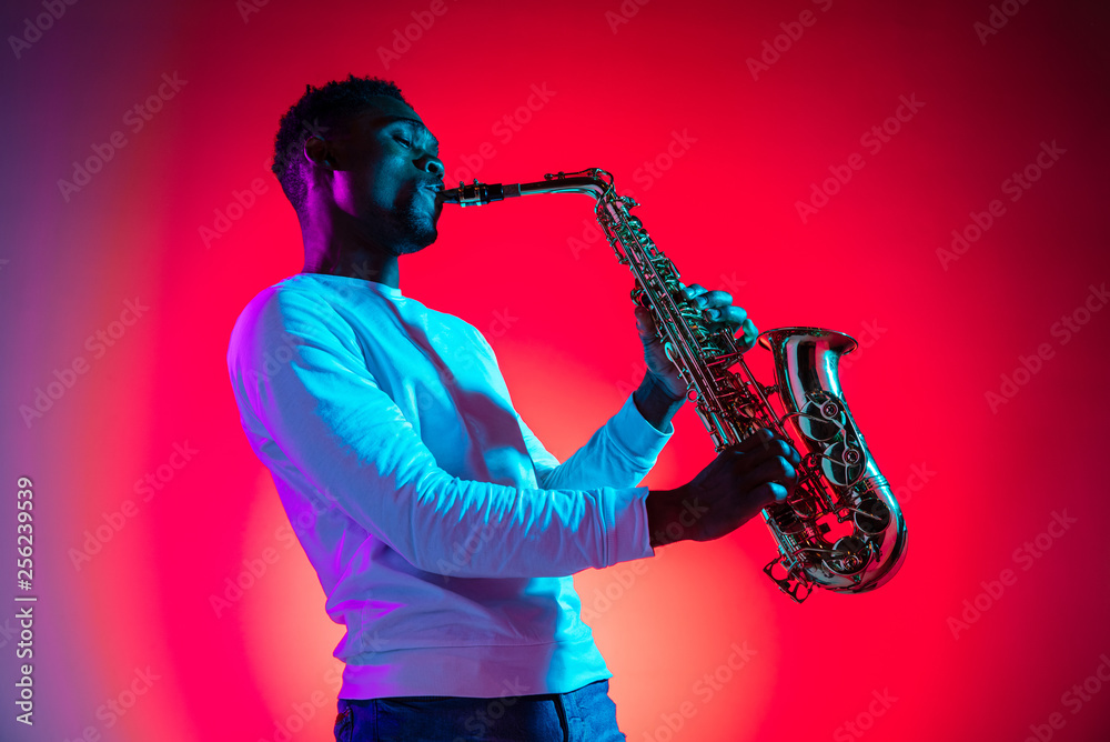 African American handsome jazz musician playing the saxophone in the ...