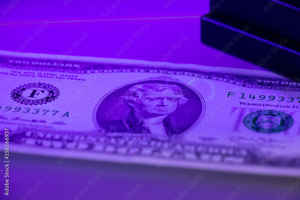 Verifying the authenticity of the two-dollar bill in ultraviolet light ...