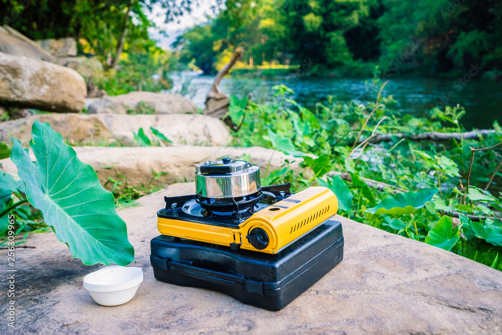 Picnic gas stove and aluminum teapot for boiling water during camping ...