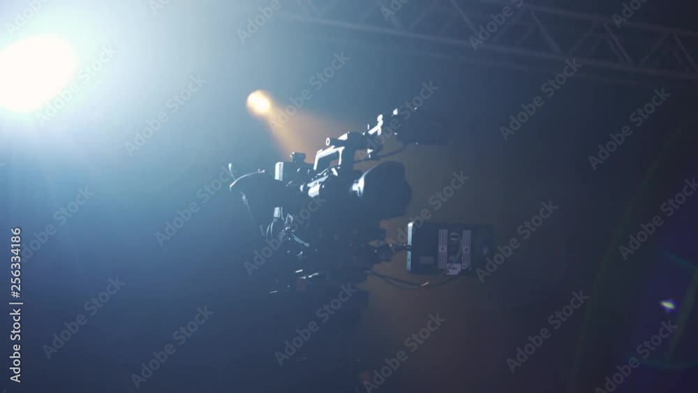 Rotation view of professional digital video camcorder with set of light ...