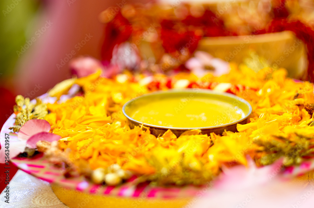 Traditional Haldi turmeric kept on a flower plate for the hindu ...