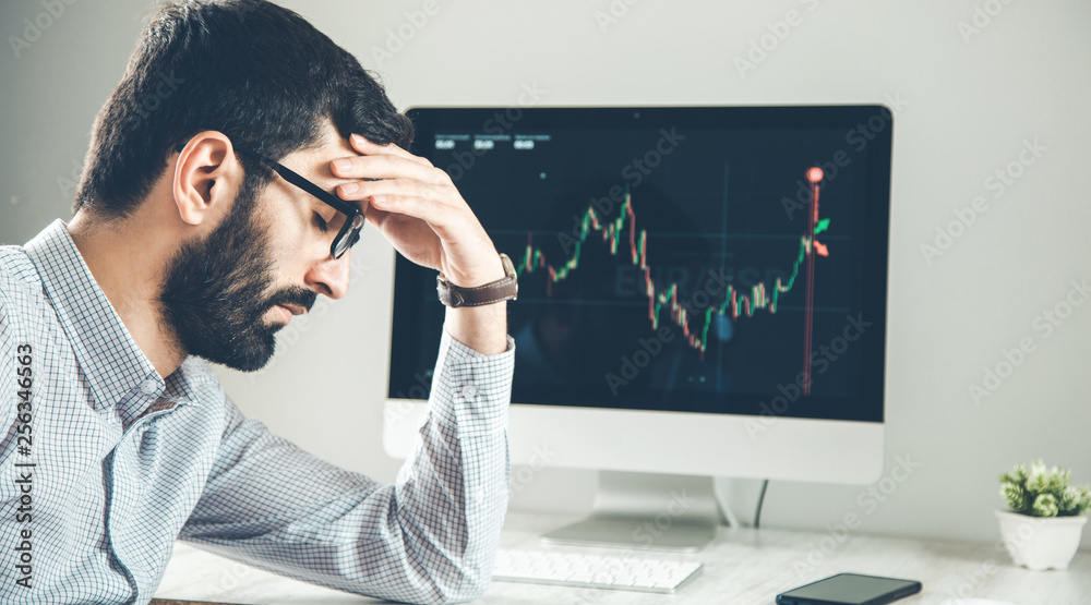 sad man with trading computer screen background Stock Photo | Adobe Stock