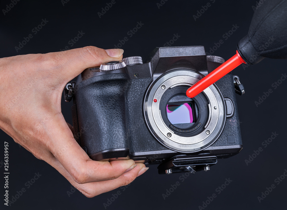 hand using air blower to cleaning dust on camera sensor Stock Photo ...