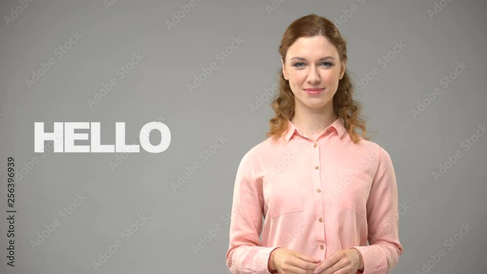 Woman saying hello in sign language, text on background, communication ...
