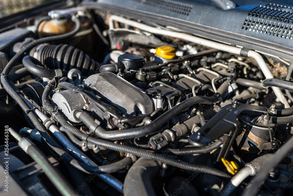 Dirty engine compartment in the used car, visible parts of the engine ...