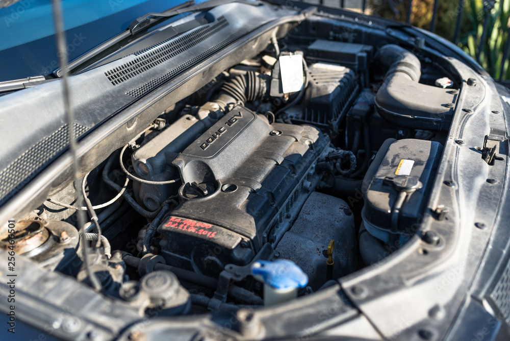 Foto de Dirty engine compartment in the used car, visible parts of the ...